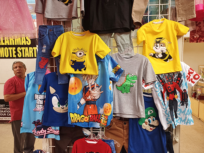 Cartoon characters and superheroes adorn kids' shirts, ready to transform ordinary children into sidewalk superheroes. Childhood joy, now 50% off!