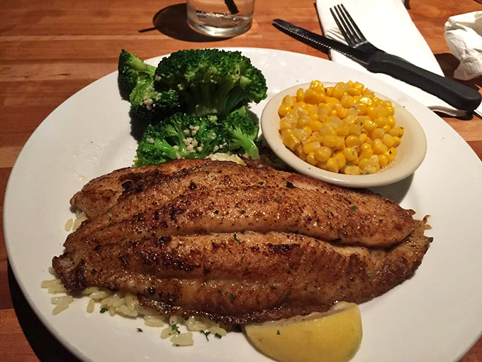 Lemon pepper whitefish on a bed of rice with broccoli and corn. Proof that healthy-ish options can still be delicious without triggering food FOMO.