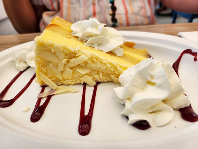 Sweet endings! Petey's lemon cake is a zesty finale to your seafood symphony, topped with a cloud of whipped cream.