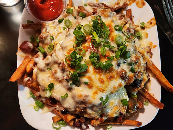 Poutine that puts on a show! This cheesy, gravy-laden masterpiece is like a flavor mosh pit for your mouth.