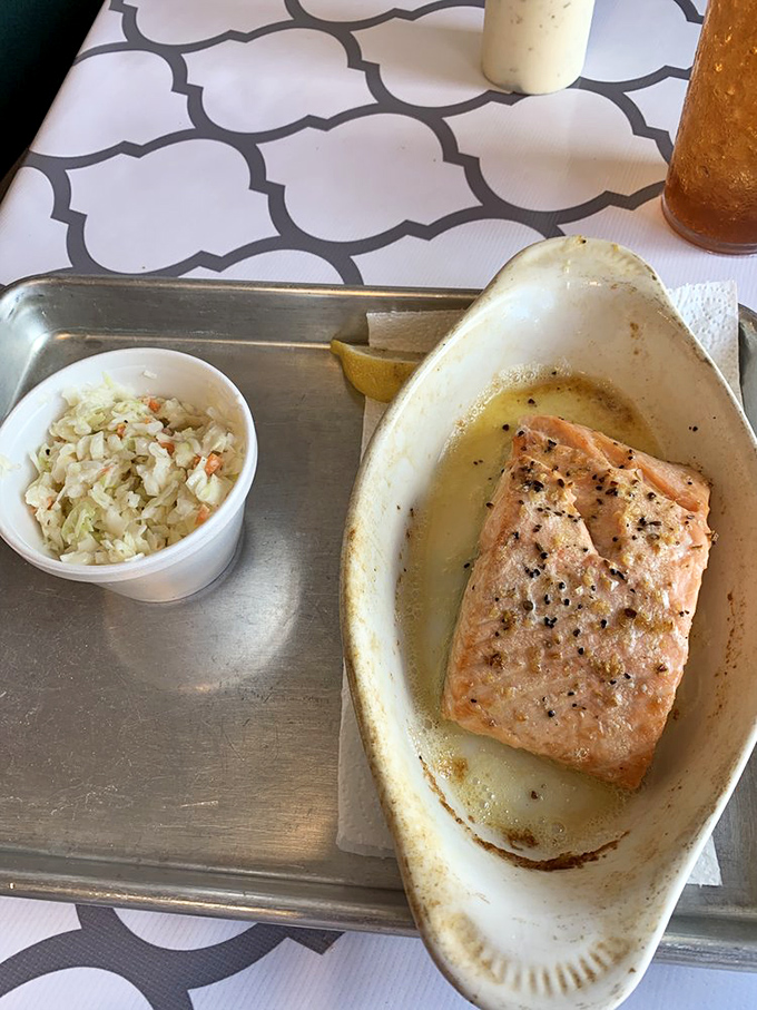 Salmon that's ready for its close-up, with a side of coleslaw that's not just here to look pretty. A dynamic duo of flavor!