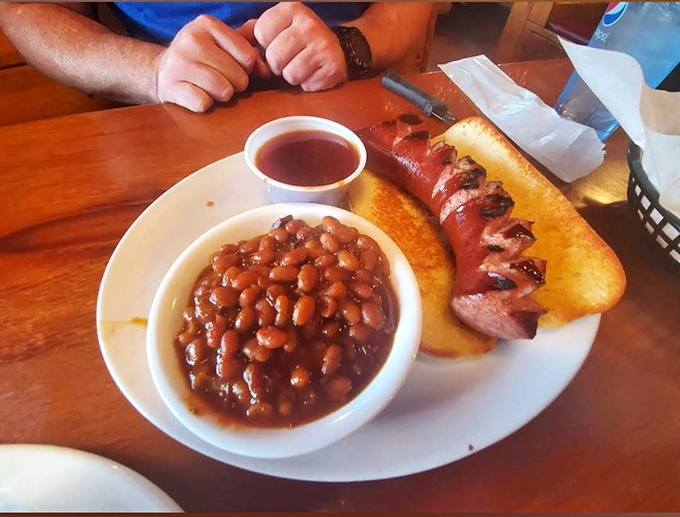 A match made in barbecue heaven: savory sausage cozying up to a bowl of beans. It's comfort food that gives you a warm, smoky hug.
