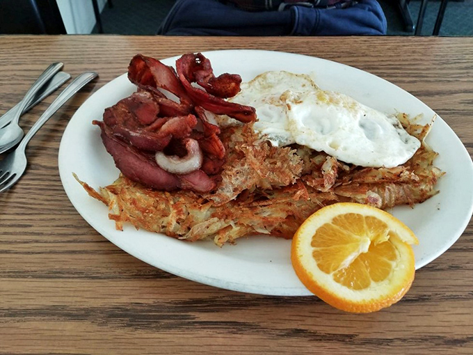 Bacon, eggs, and hash browns: the holy trinity of breakfast. With a side of orange slice for those who like to pretend they're being healthy.
