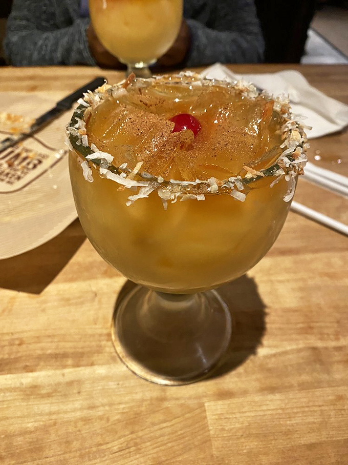 A cocktail rimmed with coconut and crowned with pineapple&mdash;because sometimes your beverage deserves to wear a tiny tropical hat.