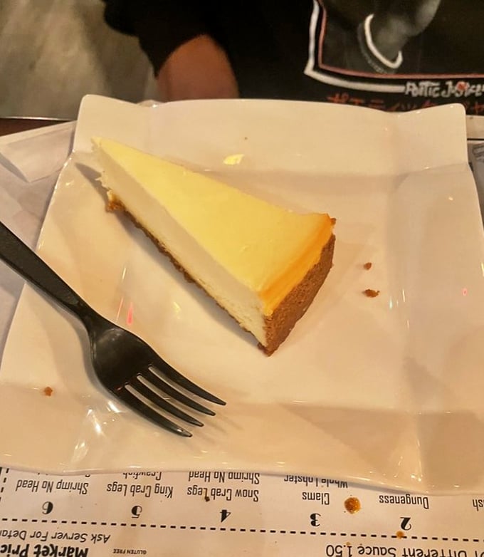 A slice of heaven on a plate. This cheesecake is smoother than a jazz saxophone and richer than Scrooge McDuck.