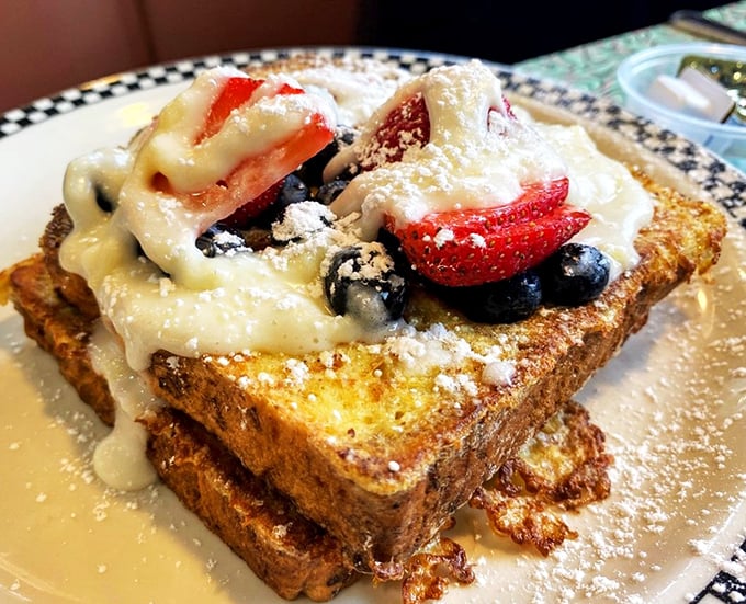 French toast elevated to art form with fresh berries and cream. This isn't just breakfast; it's what weekend mornings dream about when they grow up.