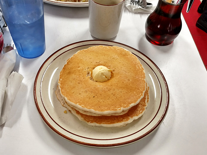Pancake perfection! These golden discs of joy, crowned with a melting pat of butter, are ready to soak up syrup like tiny, delicious sponges.