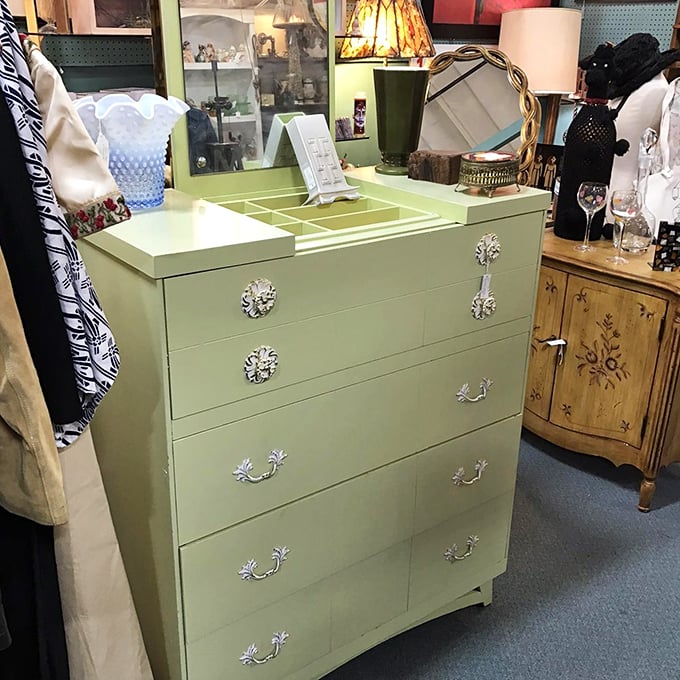 This isn't just a dresser; it's a mint-green time machine. With those fancy handles, it's clearly been taking style lessons from your great-aunt's brooch collection.