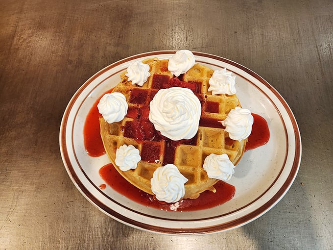 Waffle or work of art? This syrup-soaked beauty is topped with more whipped cream than a rom-com food fight. Indulgence has never looked so good.