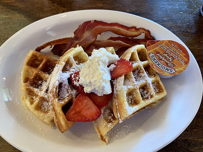 Waffle wonderland! These golden grids are ready for their maple syrup waterfall moment. Bacon's just along for the tasty ride.