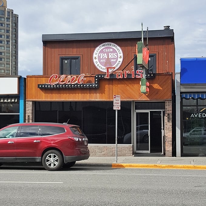 Club Paris: Where neon dreams and meaty realities collide. This Anchorage institution serves up steaks that'll make you forget you're in salmon country.