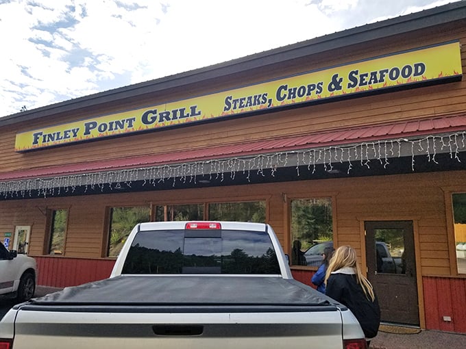 Finley Point Grill: Where the sign promises seafood and the pickup trucks confirm it's a local favorite. Rustic charm meets lakeside dining!