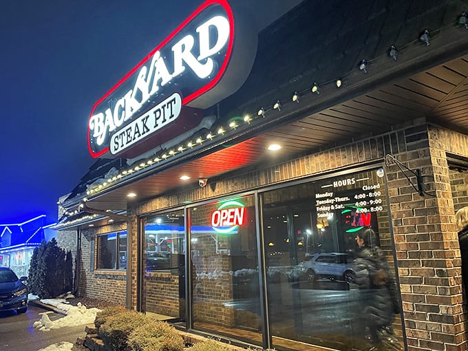 "Neon dreams and sizzling steams! The Backyard Steak Pit's sign is like a lighthouse for the beef-obsessed."