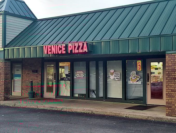 Venice Pizza: Where neon dreams and cheesy realities collide! This unassuming storefront hides a world of pizza perfection.