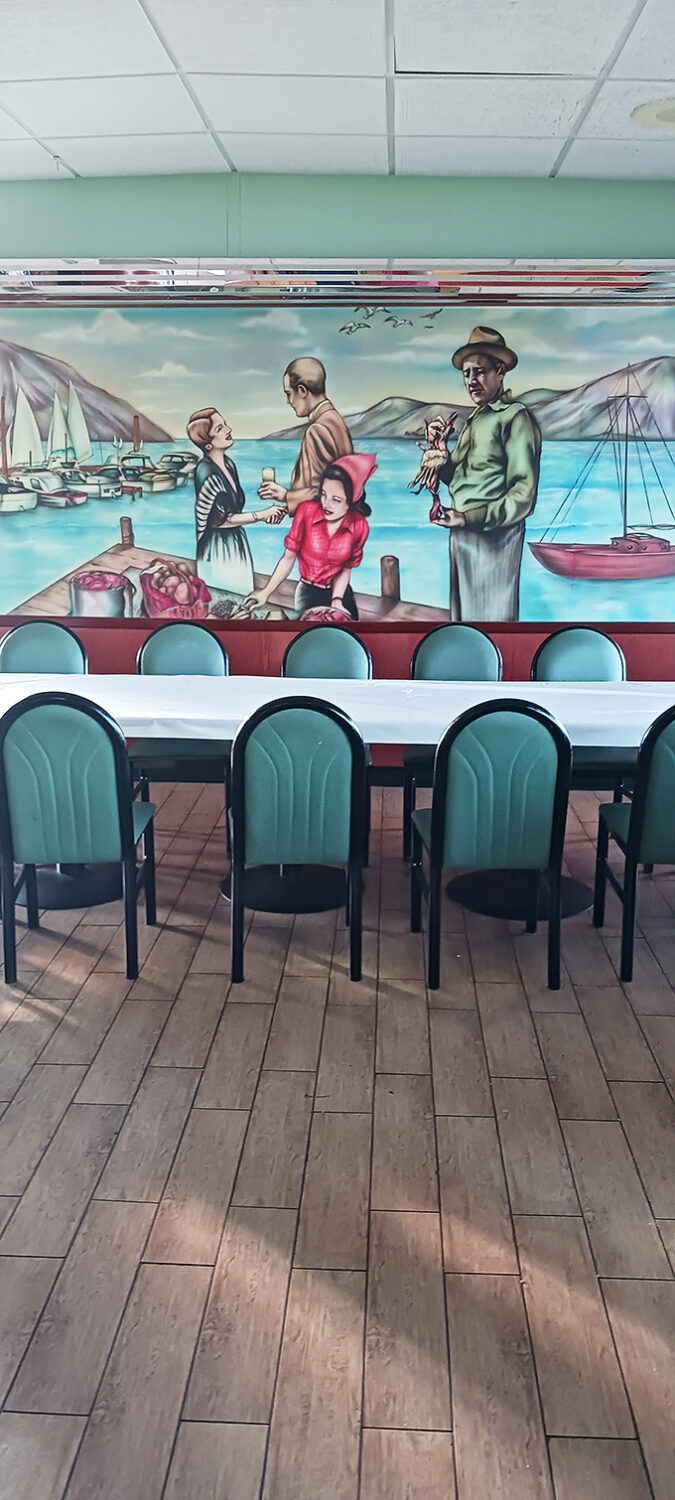 Sail away on a sea of nostalgia with this mural. It's like Norman Rockwell and Edward Hopper collaborated on the ultimate diner backdrop.