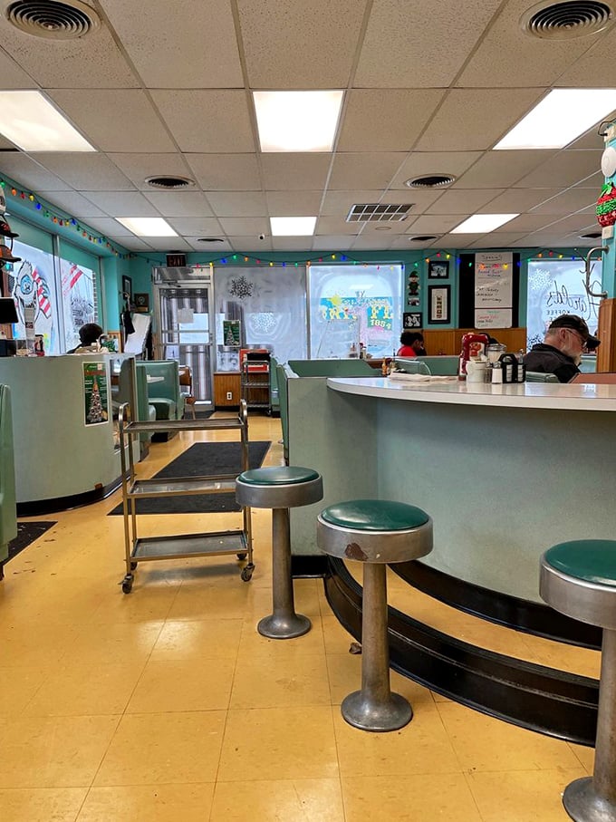 Step into a time warp of teal and chrome. This diner's retro charm whispers tales of countless cups of joe and hearty laughs shared.