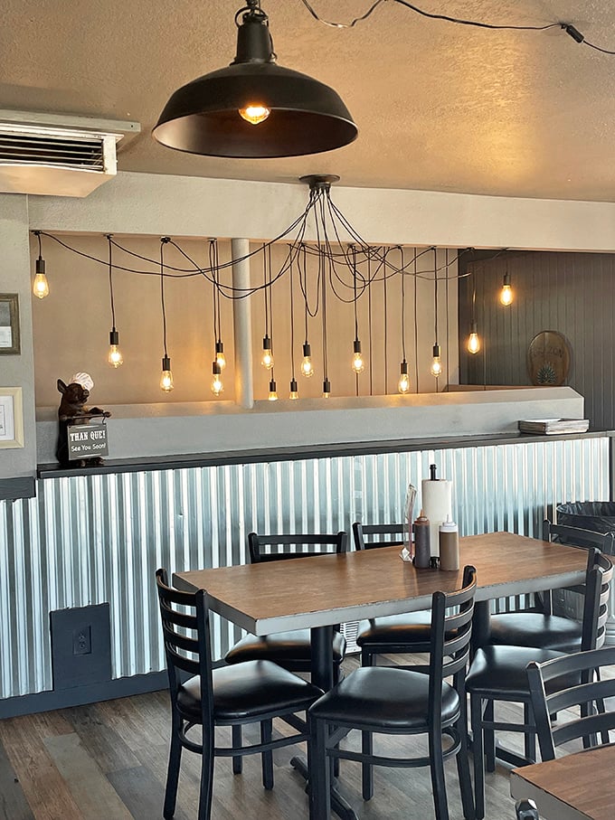 Edison bulbs and corrugated metal create an ambiance that's part industrial chic, part cozy BBQ joint. It's like a hug for your eyes!