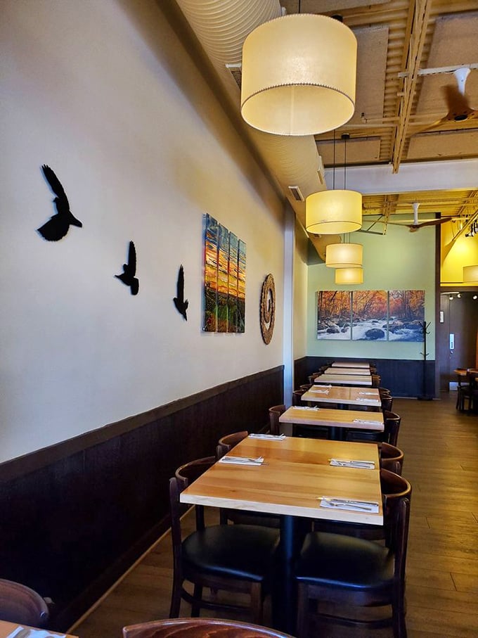 Bird silhouettes take flight along walls bathed in warm light, creating an atmosphere where even committed meat-eaters feel mysteriously at home.