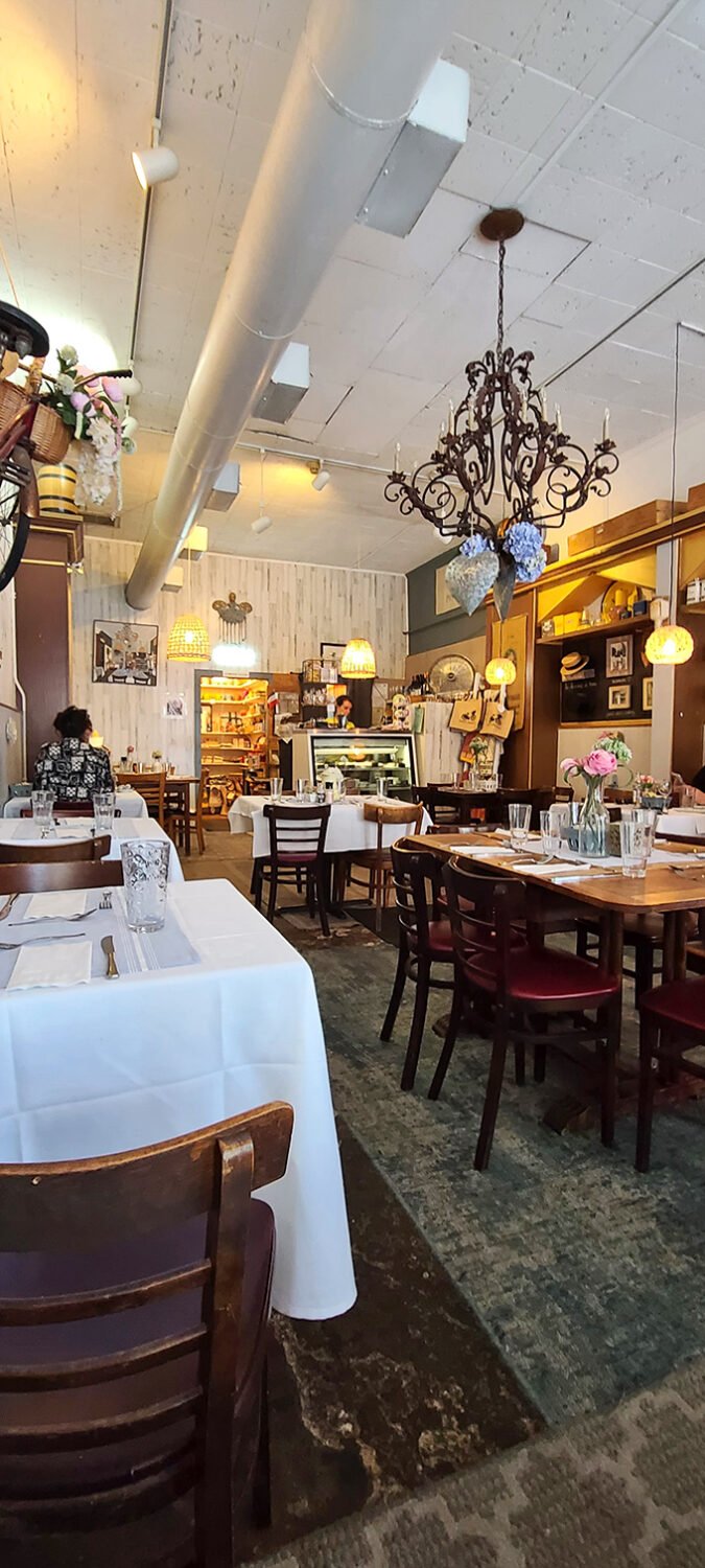 Step inside and be transported to a cozy French bistro. The chandelier whispers, "Oui, you're in for a treat!"