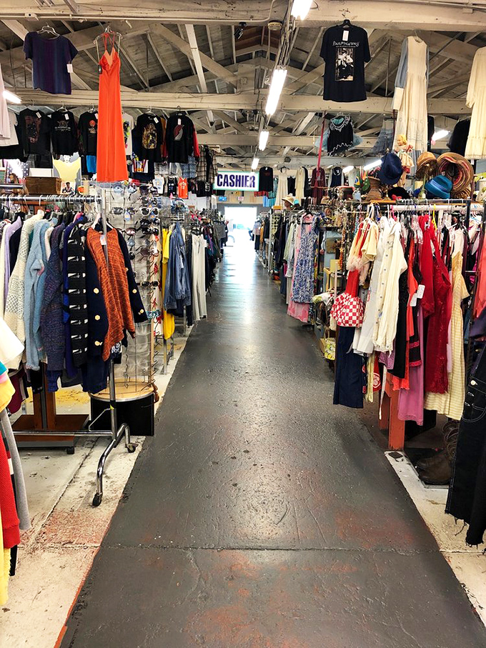 Vintage paradise stretches before you in neat rows, creating a time-travel corridor where every hanger holds a story waiting to be continued.