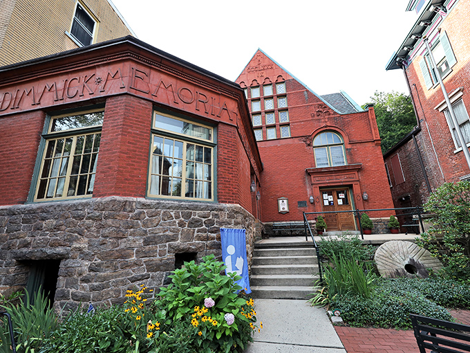 The Dimmick Memorial Library doesn't just house books; it cradles stories within its stone foundation and crimson walls, a literary sanctuary amid mountain air.