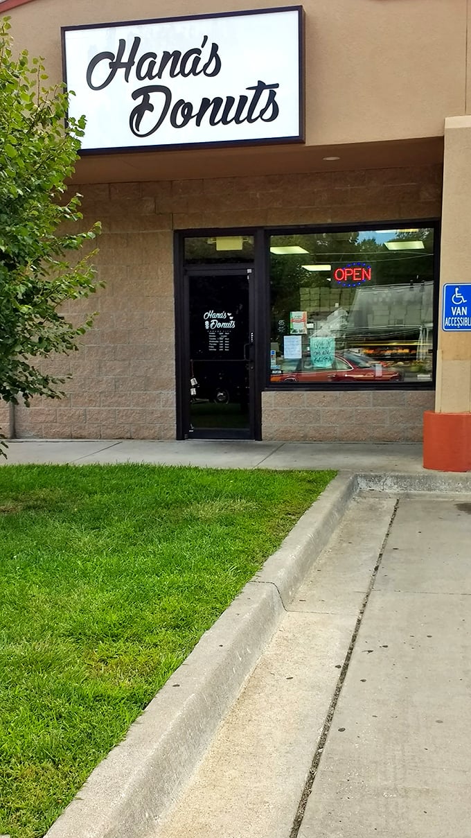 Step right up to flavor town! The entrance to Hana's Donuts is like a portal to a world where calories don't count and happiness is glazed.