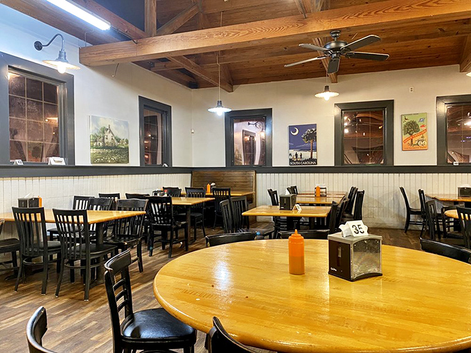 Wooden beams, rustic tables, and South Carolina artwork create the perfect backdrop for the comfort food magic that happens here daily.