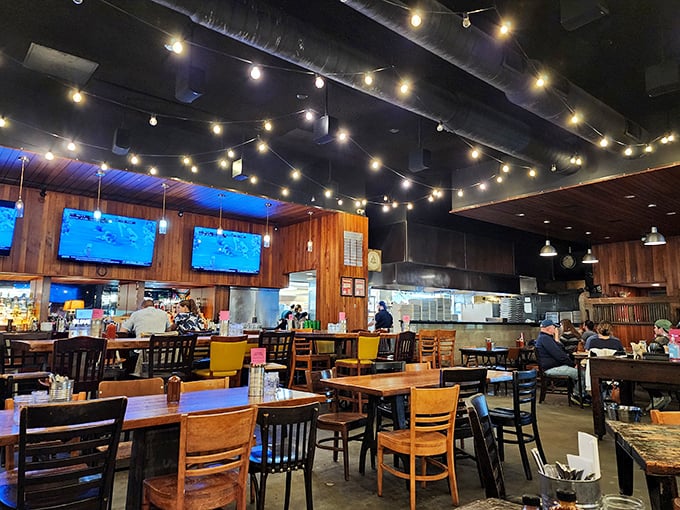 String lights cast a warm glow over wooden tables and mismatched chairs, creating an atmosphere that says "stay awhile" without trying too hard.