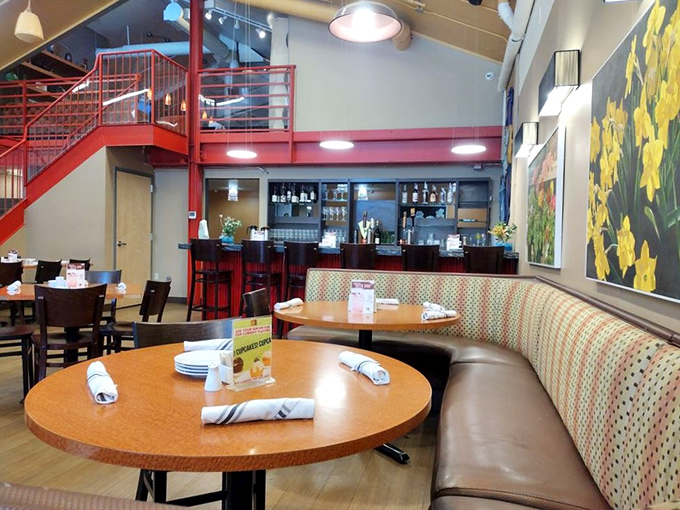 That vibrant red staircase isn't just architectural flair—it's your pathway to the Wine Loft upstairs. Downstairs for comfort food, upstairs for comfort wine!