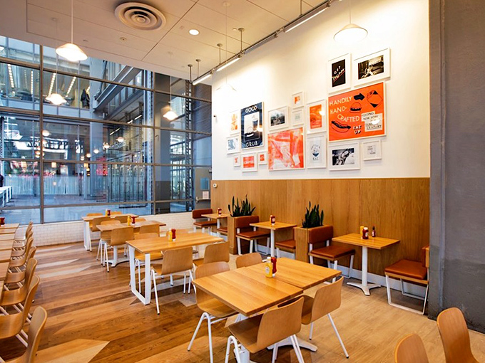 Clean lines, warm wood, and floor-to-ceiling windows create the perfect backdrop for food that doesn't need fancy lighting to look good.