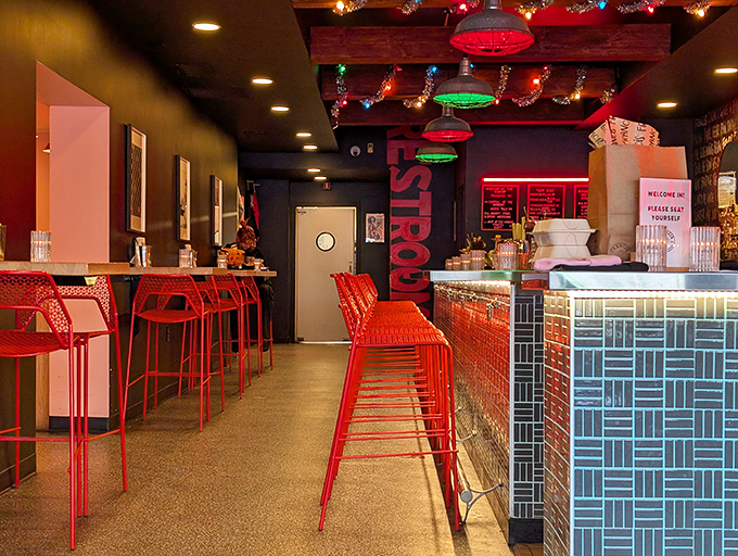 Step into a burger lover's dream! The vibrant red chairs and funky lighting create an atmosphere that's as bold as the flavors on your plate.