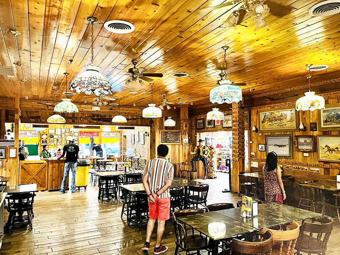 Step into a time capsule of Americana! Wall Drug's interior is a feast for the eyes, with its warm wood paneling, Tiffany-style lamps, and enough cowboy decor to make John Wayne feel right at home.