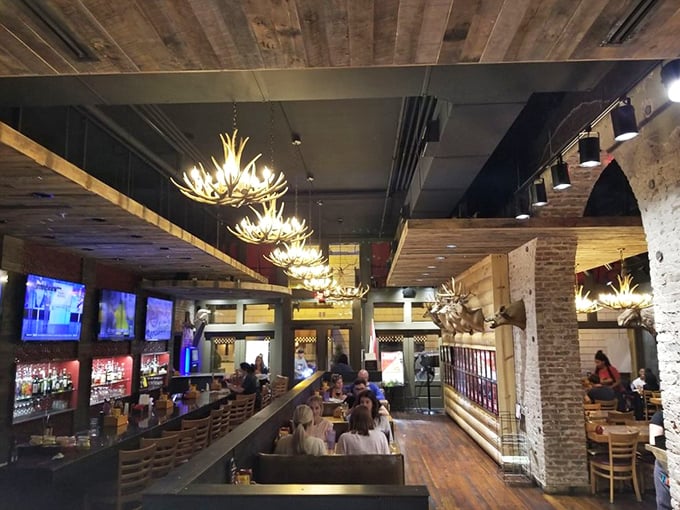 Step inside and you'll feel like you've wandered into a lumberjack's dream man cave. Antler chandeliers? Check. Mounted deer heads? You betcha. Cozy cabin vibes? Absolutely!