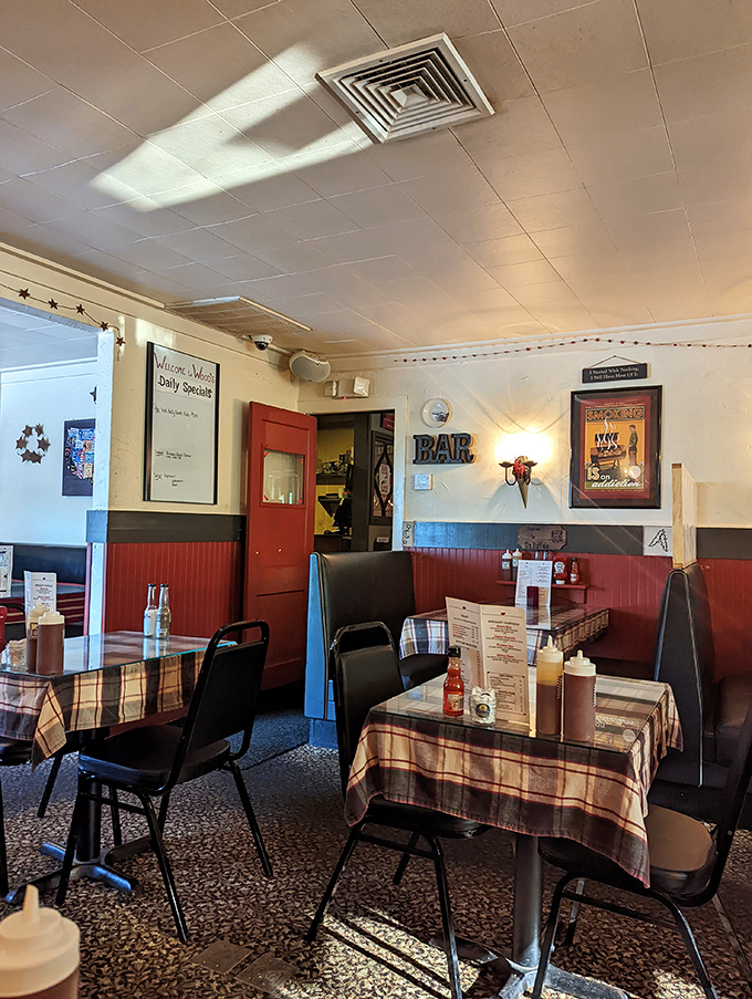 Step into a cozy time capsule of comfort! The interior's red wainscoting and plaid tablecloths set the stage for a down-home dining experience.
