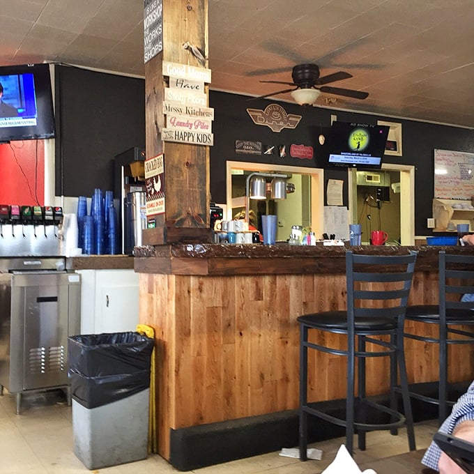 Step into a time machine disguised as a diner. With its wood-paneled charm and quirky signs, this interior screams "comfort food ahead!" louder than your grandma at bingo night.