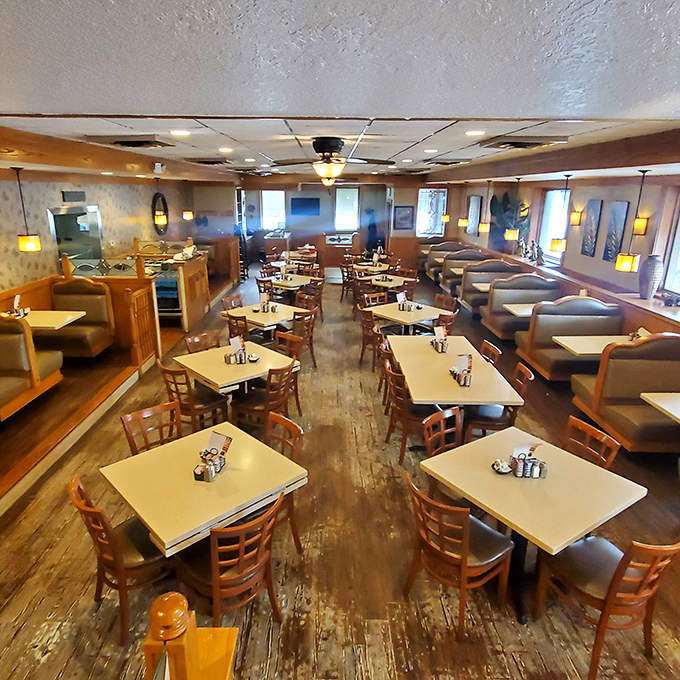 Step into a world where breakfast reigns supreme. The warm, wood-paneled interior feels like a hug from your favorite aunt – comforting and full of promise.