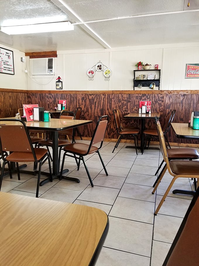 Step into a time capsule of comfort. This cozy interior, with its wood paneling and simple tables, whispers tales of countless satisfied diners.