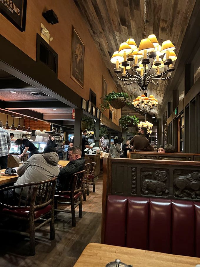 Chandeliers and charm! Step into The Kettle's warm embrace, where elegant lighting meets cozy booths, creating the perfect backdrop for memorable meals and lively conversations.