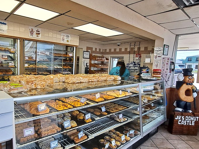 Donut nirvana awaits! Rows of golden-brown beauties beckon, their glazed surfaces glistening like edible jewels in this carb-lover's paradise.