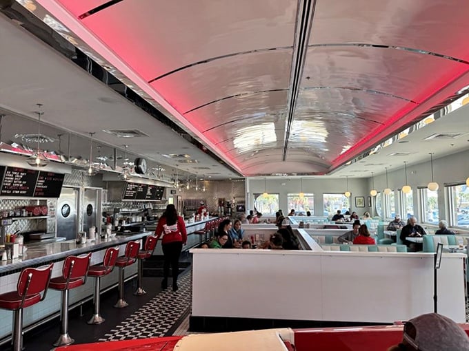 Inside, it's all chrome and dreams. The curved ceiling and red accents make you feel like you're dining in a classic '50s convertible.
