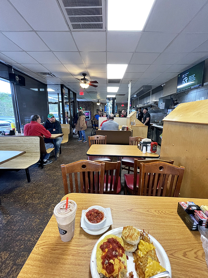 Step into a time capsule of comfort. This no-frills interior whispers tales of countless satisfying meals and bottomless cups of coffee.