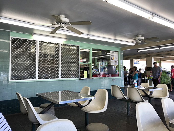 Retro chic meets island vibes in this no-frills dining area. It's like stepping into a time machine that serves comfort food!