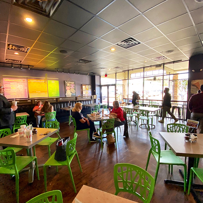 Step inside and feast your eyes on a pizza lover's paradise. Those vibrant green chairs? They're not just seating, they're your front-row tickets to flavor town.