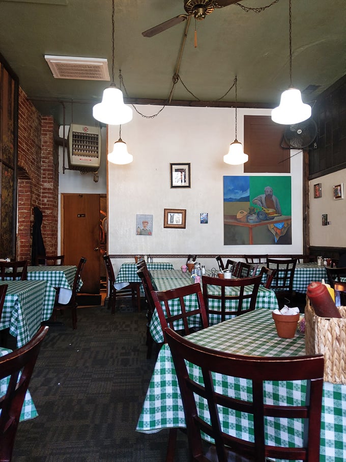 Checkered tablecloths and local art create a cozy atmosphere that's part Norman Rockwell, part hipster haven. It's like your cool grandma's dining room got a makeover!