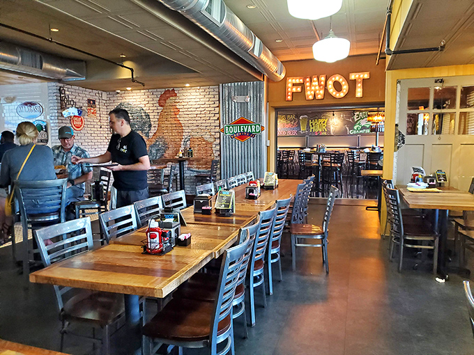 Step into a wing lover's paradise! With its industrial-chic vibe and "FWOT" sign, this place screams "cool hangout" louder than a teenager's bedroom stereo.
