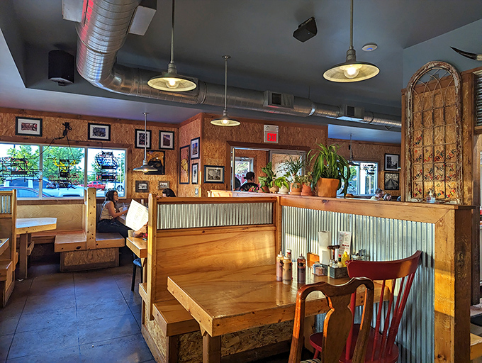 Wooden booths, corrugated metal accents, and warm lighting create that perfect "I've just discovered my new favorite spot" atmosphere. Comfort begins before the food arrives.