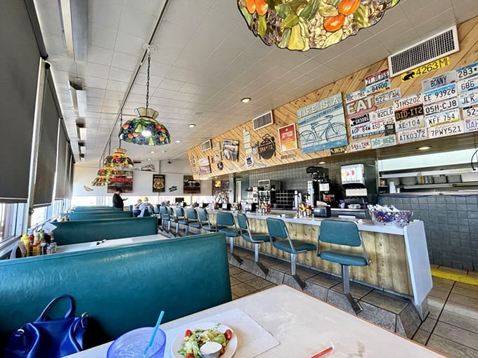 Classic turquoise booths and colorful stained glass lamps create the perfect backdrop for morning conversations and coffee refills that never end.