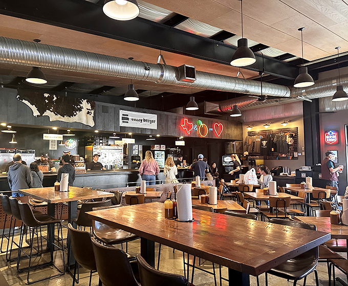 Industrial chic meets meat-lover's paradise inside ZZQ, where the neon Texas outline serves as a beacon guiding hungry souls to smoky salvation.