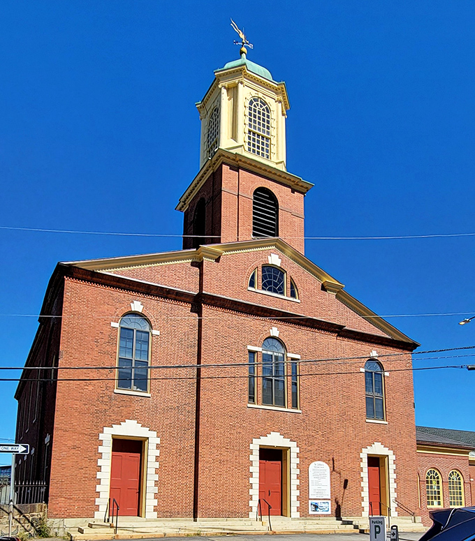 Holy architectural eye candy! This brick beauty stands tall, as if saying, "I've seen it all, from powdered wigs to man buns."