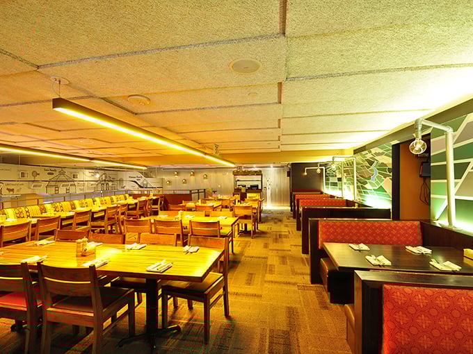 Warm wooden tables bathed in amber light create the perfect stage for food that makes you want to hug the chef.